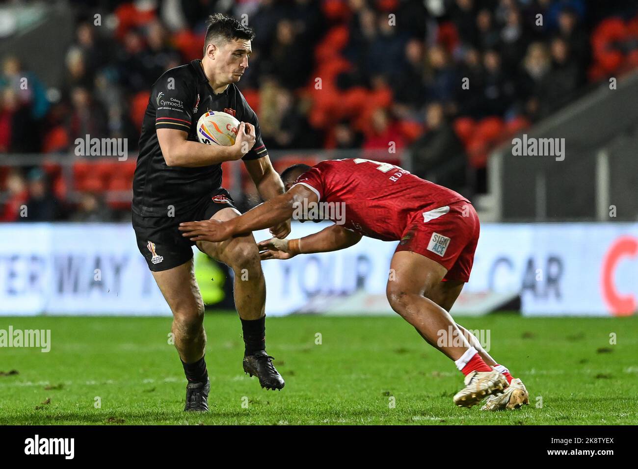 Joe Burke of Wales is tackled by Moeaki Fotuaika of Tonga during the ...