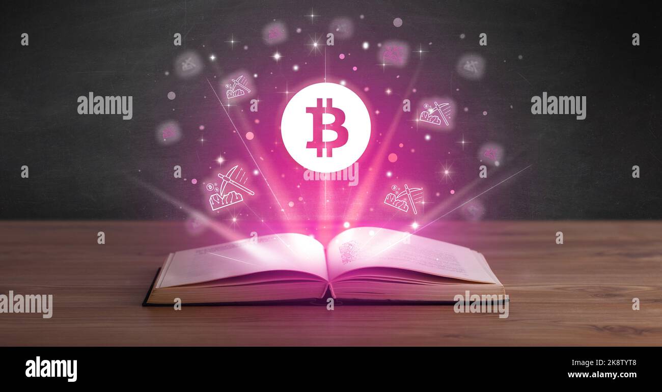 Open book with currency icons above Stock Photo - Alamy