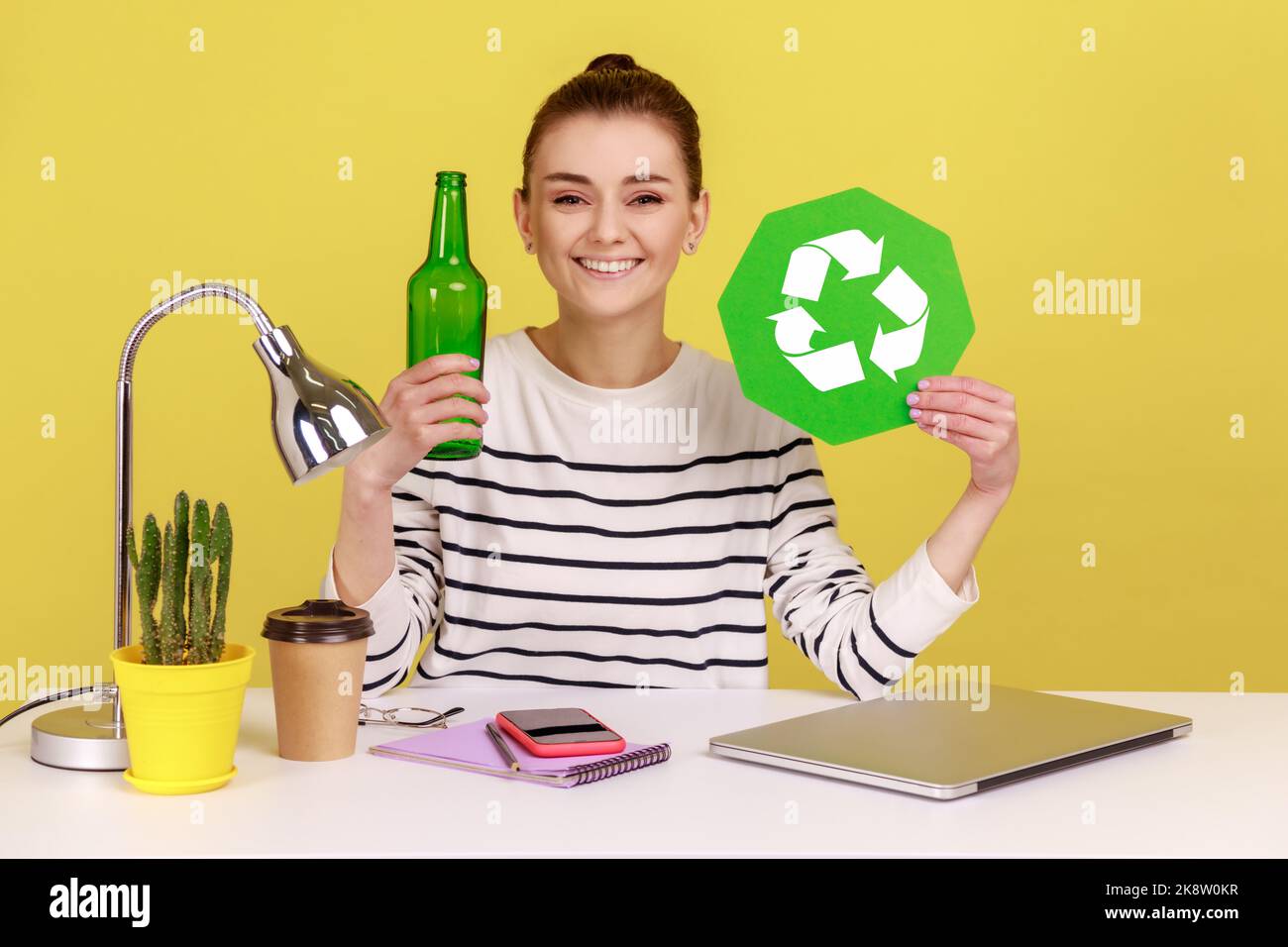 Responsible self confident happy woman holding green recycling sign in ...