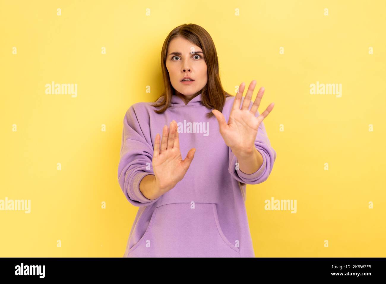 No, it's scary. Portrait of frightened shocked woman raising hands in ...