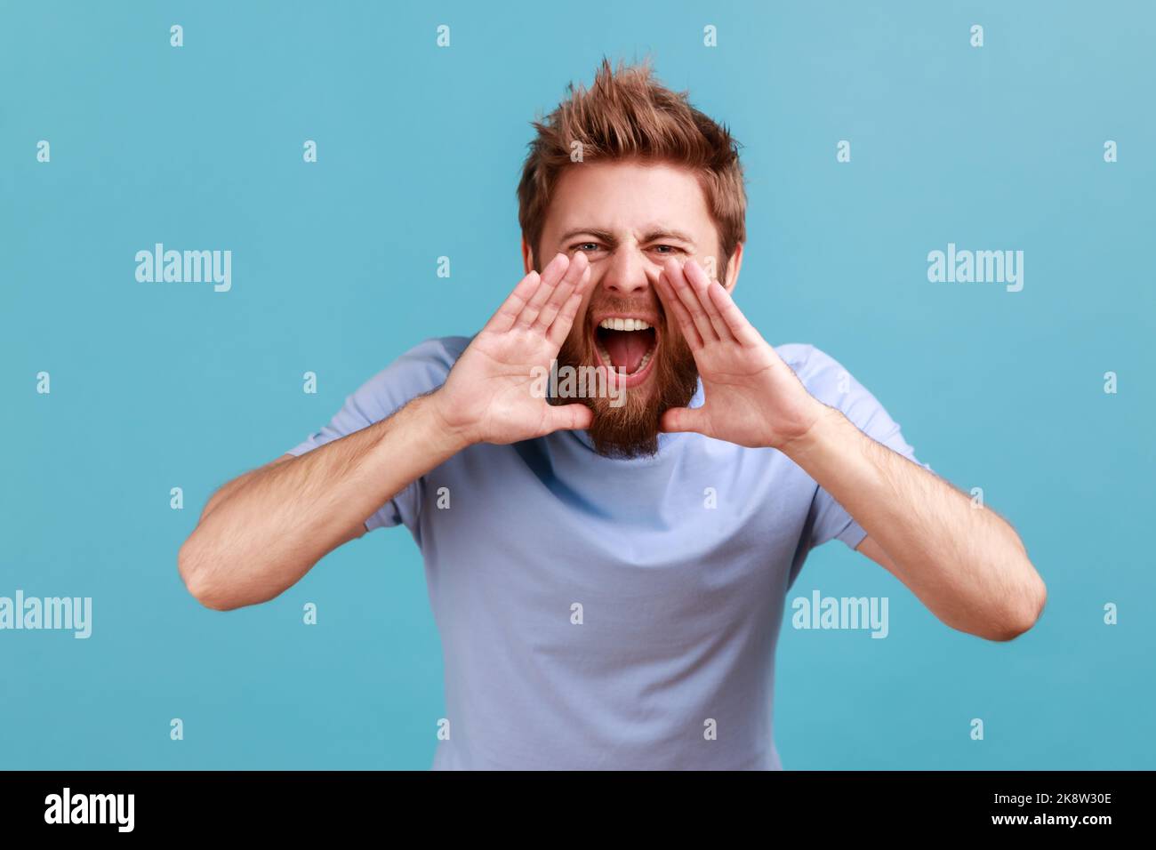 Portrait of angry nervous bearded man loudly yelling widely opening ...