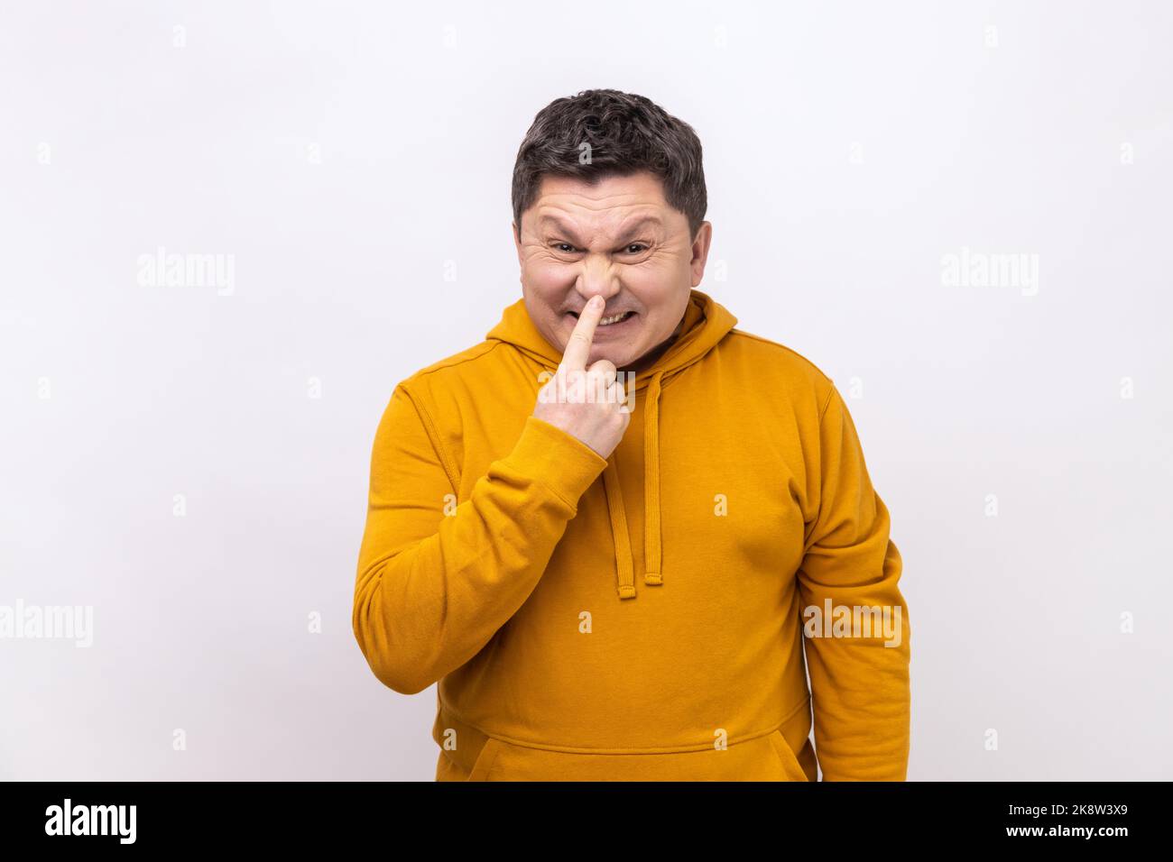 Portrait of angry man touching nose with finger, showing liar gesture ...