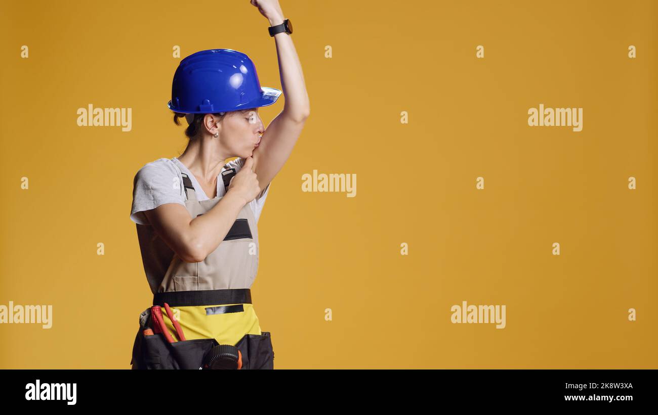Strong empowered woman flexing arm muscles in studio, preparing to work ...