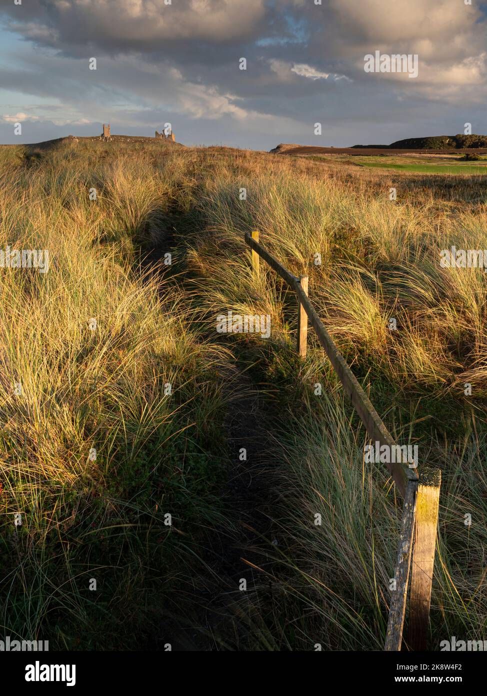 Dunstanburgh Castle at sunset. Embleton Bay, Alnwick, Northumberland ...
