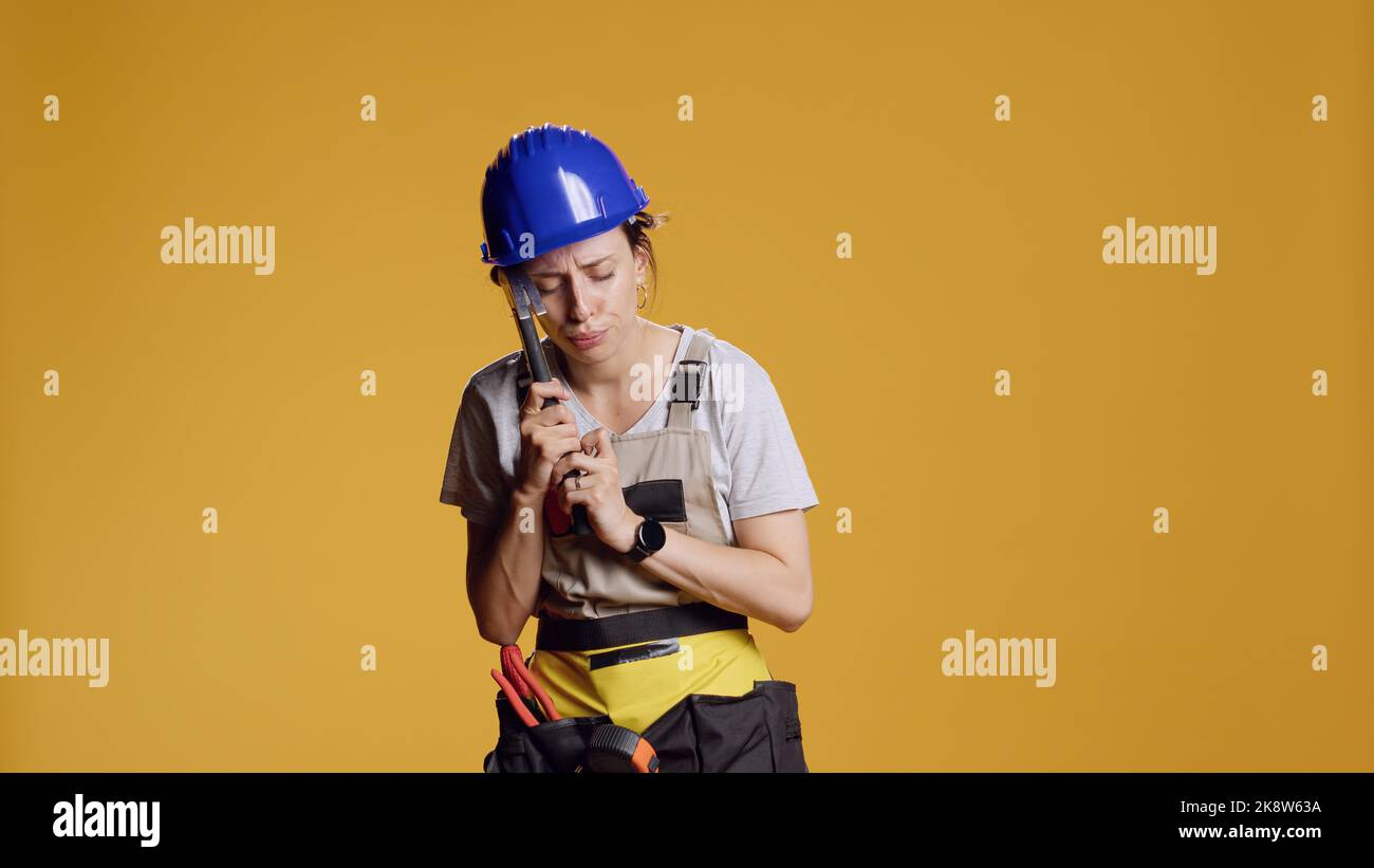 Portrait of powerful female builder having headache at construction ...