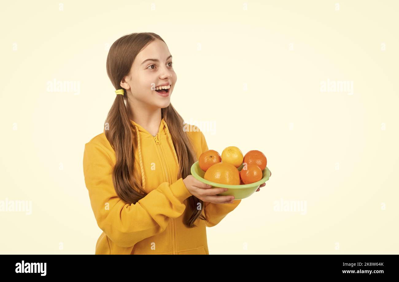 happy teen girl with citrus fruit plate. vitamin and dieting. child ...