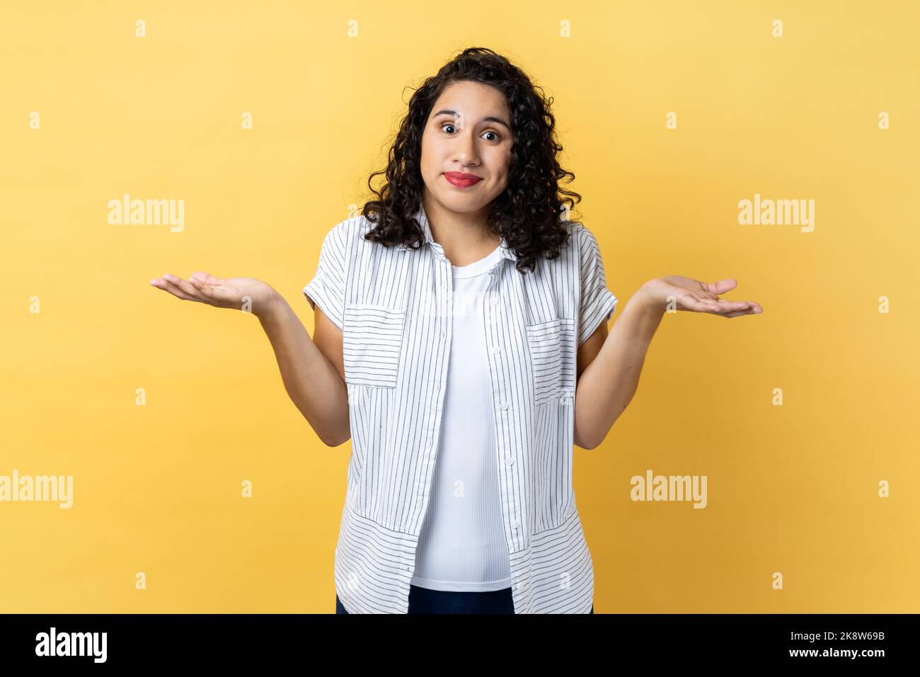 I am not sure. Portrait of ambiguous woman with dark wavy hair standing ...