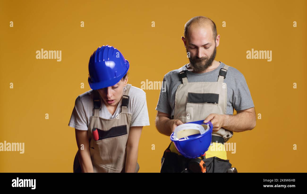 Team of tired construction workers feeling sleepy before repair work ...