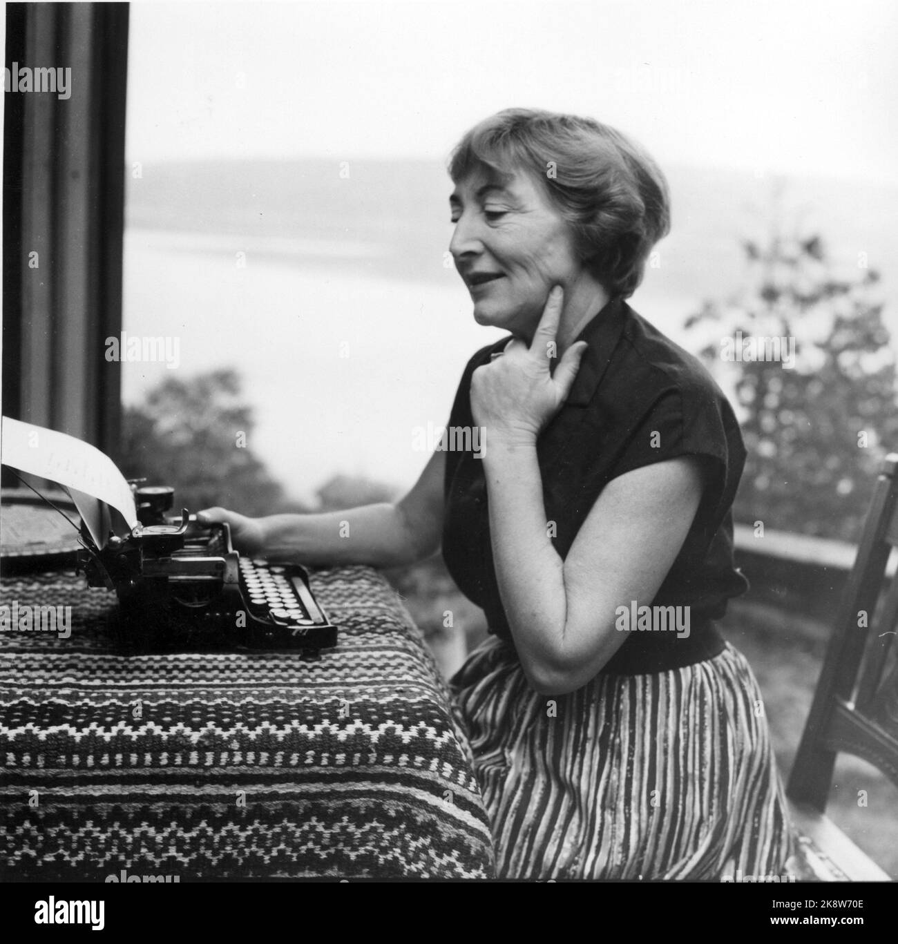 Oslo 19581014. Author Torborg Nedreaas, at the typewriter in his home ...