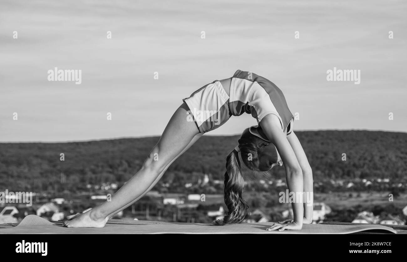 teen girl wear sportswear for training stretching on sky background ...