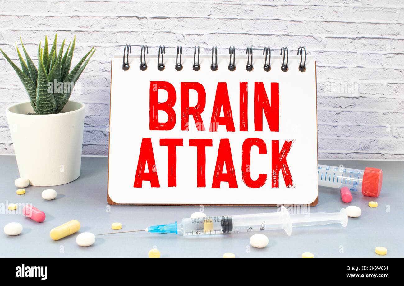 Doctor holding a pen and paper plate with text Brain Attack, medical ...