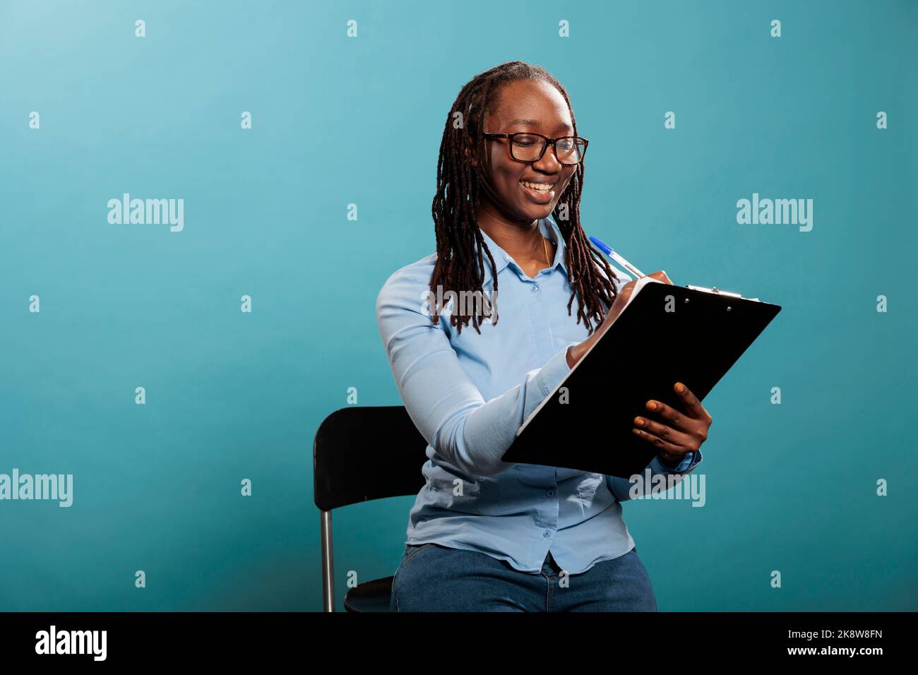 Happy confident african american woman with clipboard documentation ...