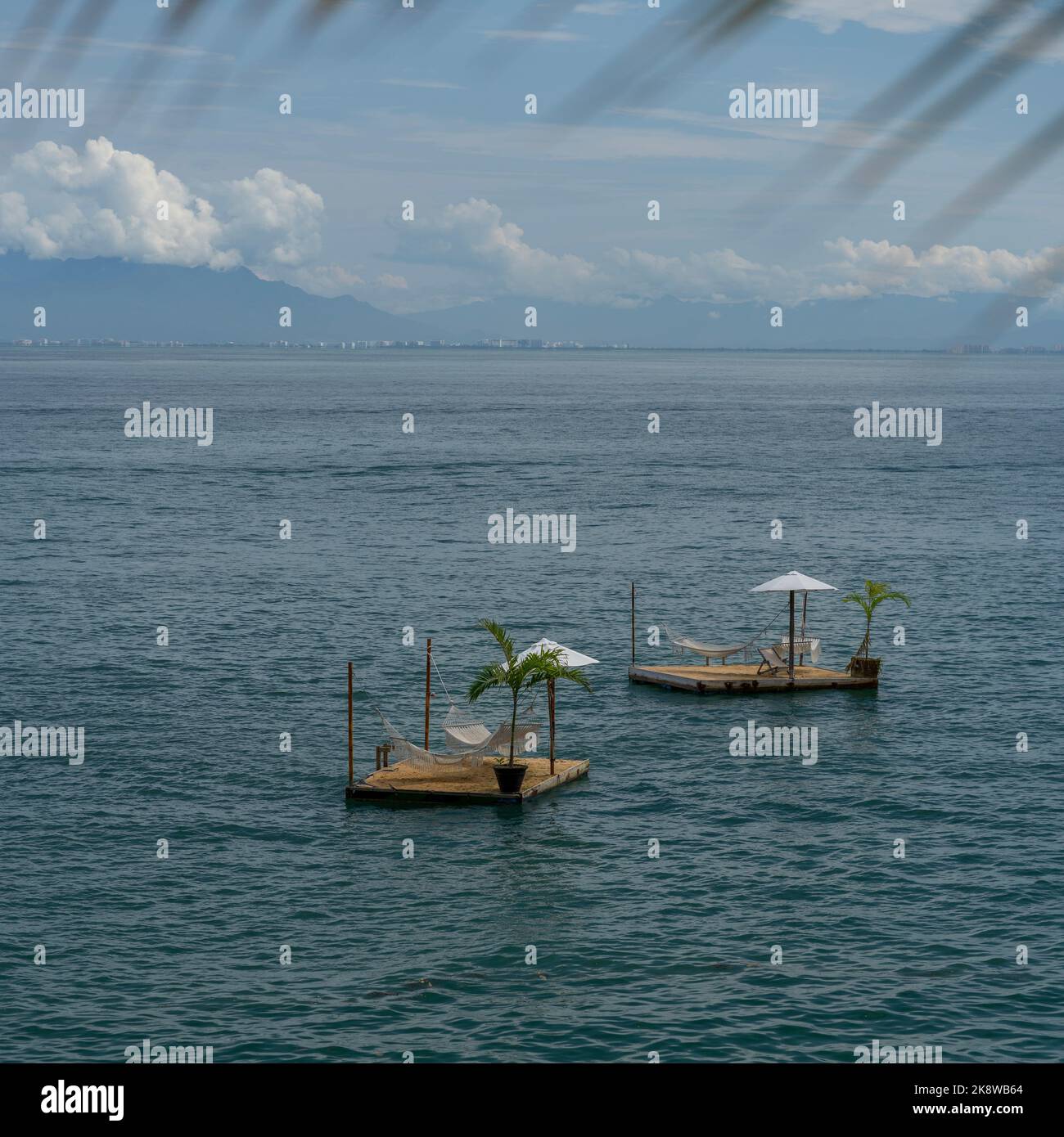 hammocks on floating rafts on the beach Stock Photo - Alamy