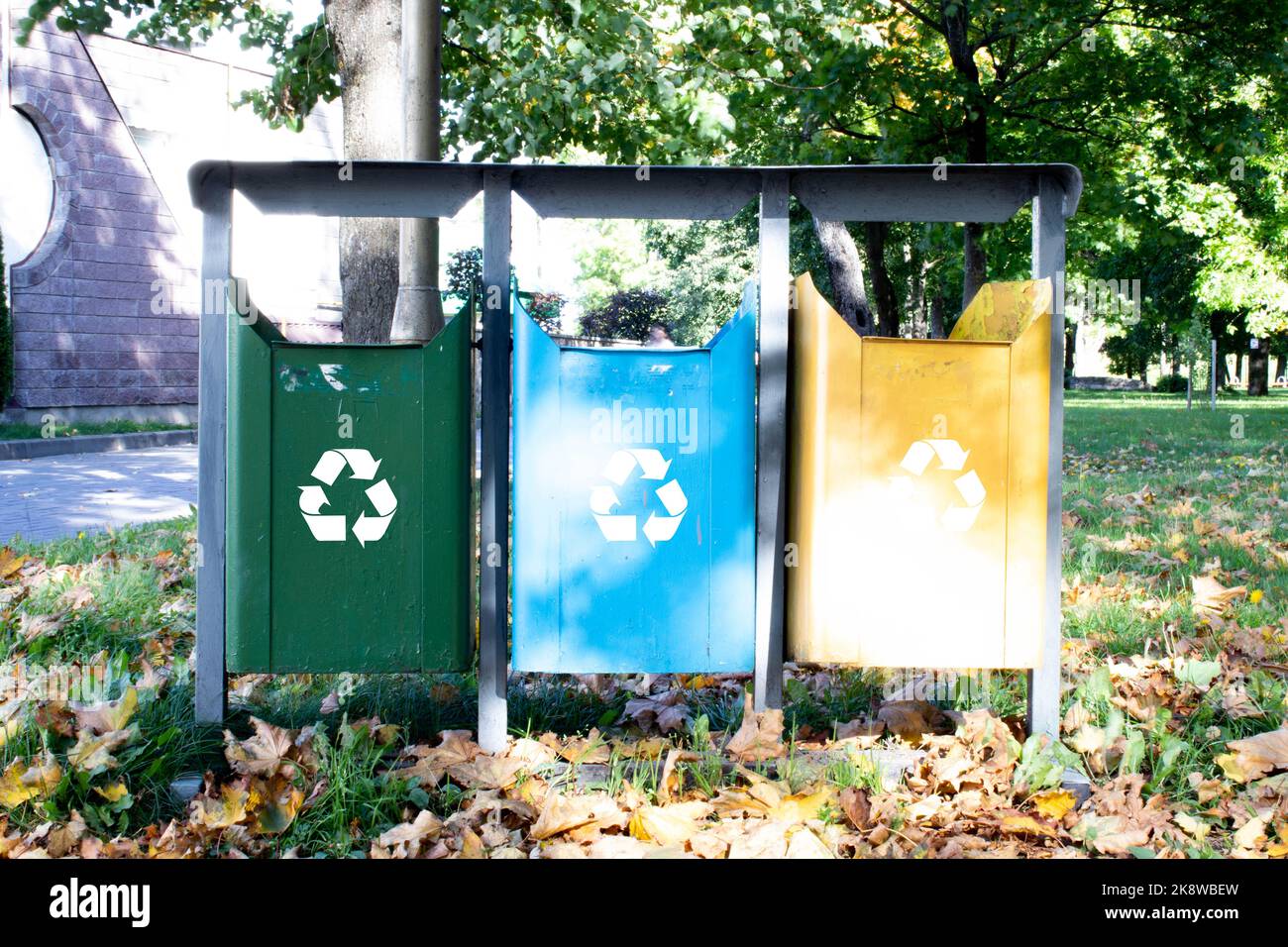 Multicolor yellow, green, blue garbage trash bins blank space. Waste ...