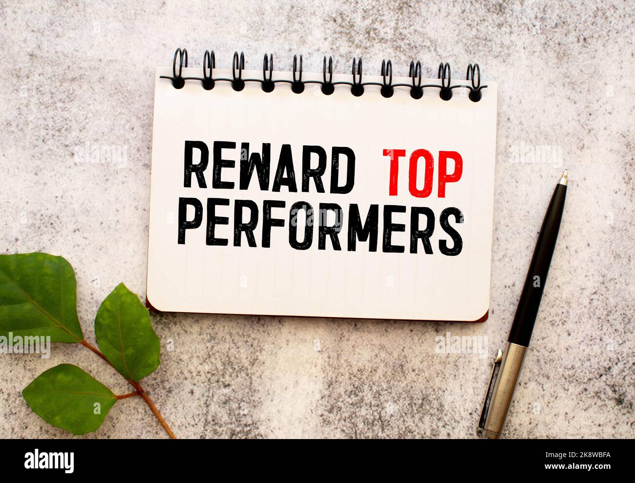 Reward top performers text memo written on a white background with ...