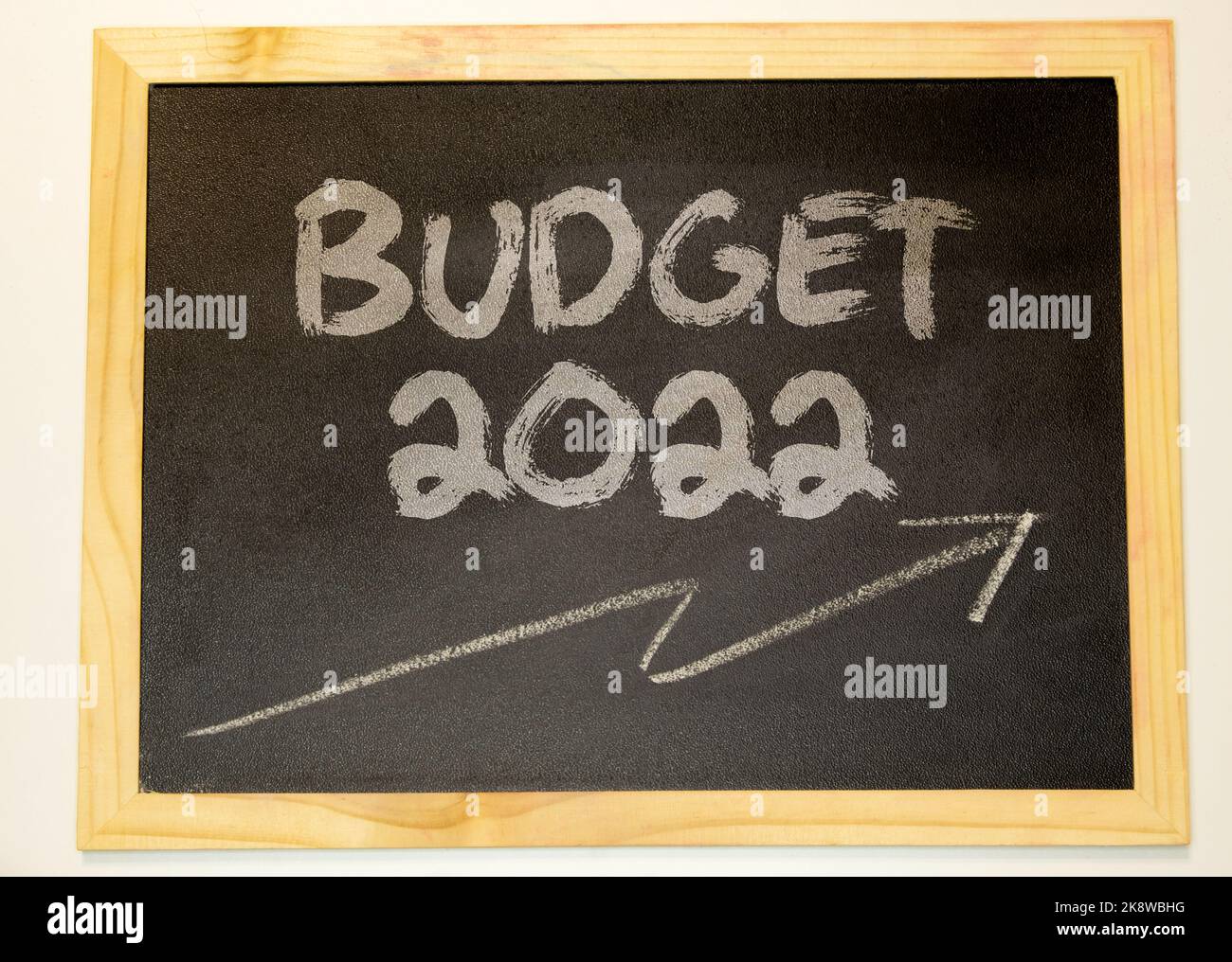 text BUDGET 2022 . Top view of closed black cover notebook on desk ...