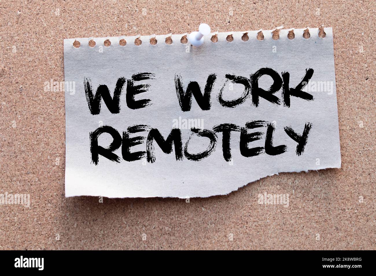 Business man pointing to transparent board with text: Work From Home ...