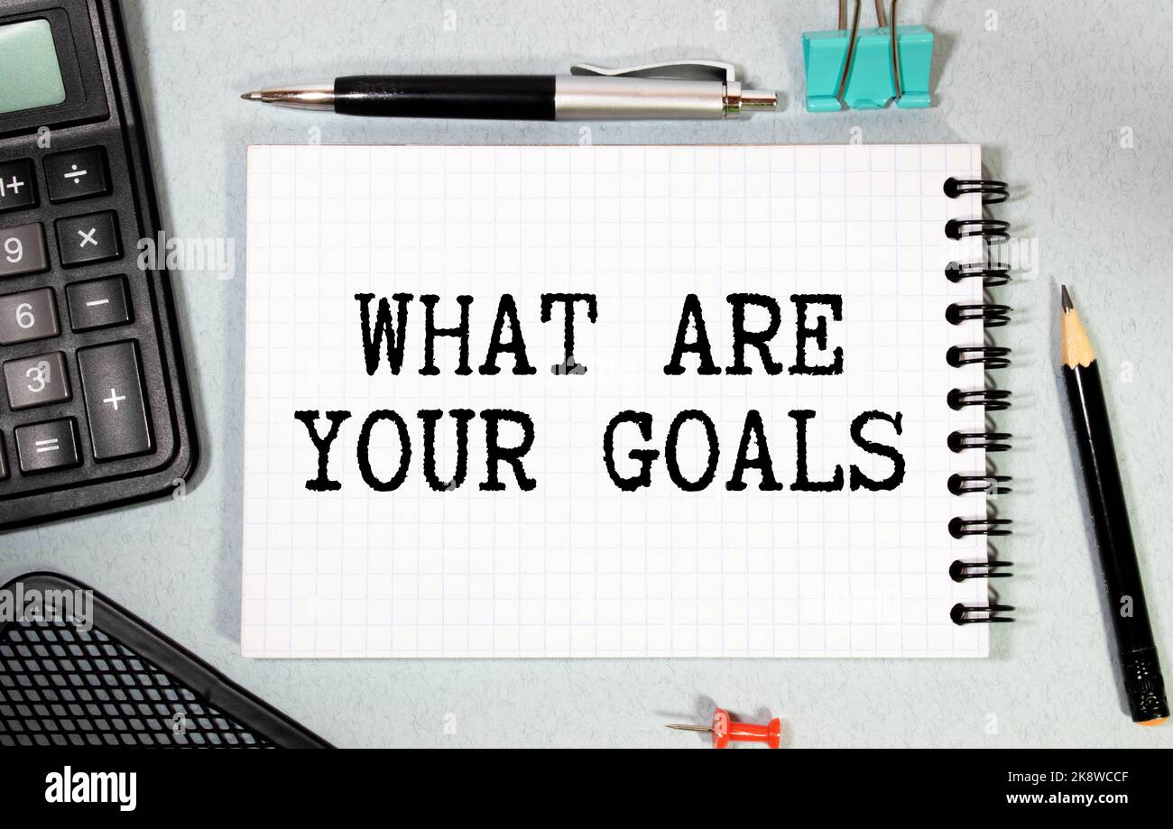 The phrase Write Down Your Goals written on a piece of paper and pinned ...