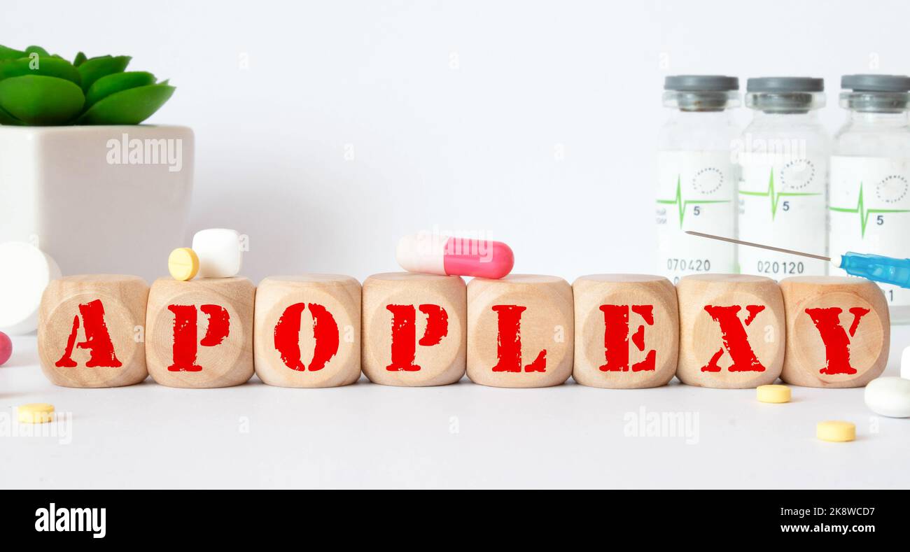 The words APOPLEXY is made of wooden cubes on a red background with ...