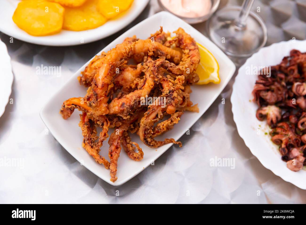 Traditional spanish beer snack - baked squid tentacles Stock Photo - Alamy