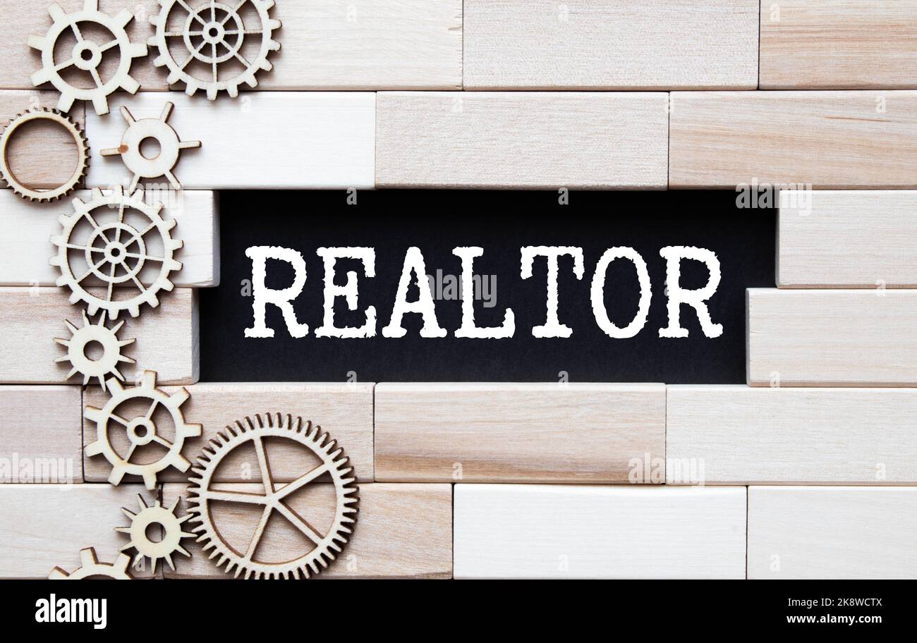 Cubes form the word realtor in front of a miniature house Stock Photo ...
