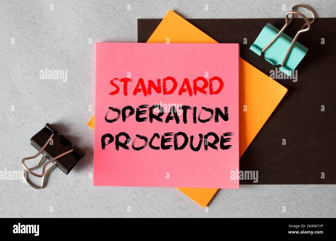 Standard Operating Procedure text on paper in open diary with ...