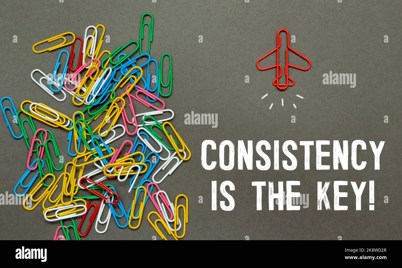 CONSISTENCY IS THE KEY, text on white paper on gray background Stock ...