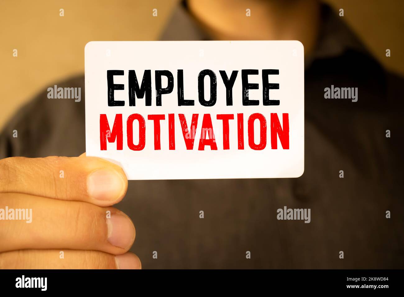 Employee motivation. Businessman holding a card with a message text ...