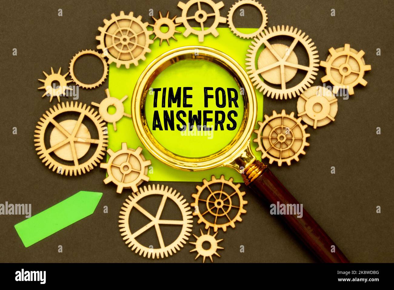 TIME FOR ANSWERS text on a magnifying glass that rests on a black ...