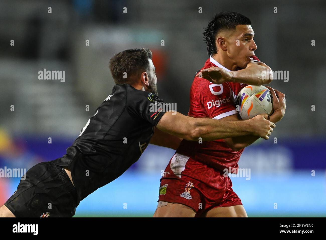 Soni Luke of Tonga is tackled by Elliot Kear of Wales during the Rugby ...