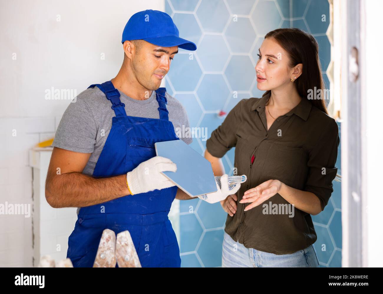 Female owner consults with a professional builder about installing a ...