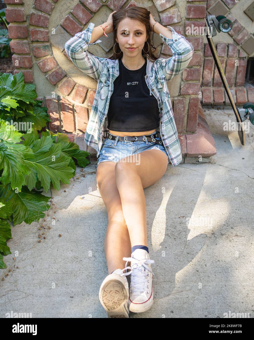 Skateboarder Girl Sitting Outside a Building at SJSU Stock Photo - Alamy