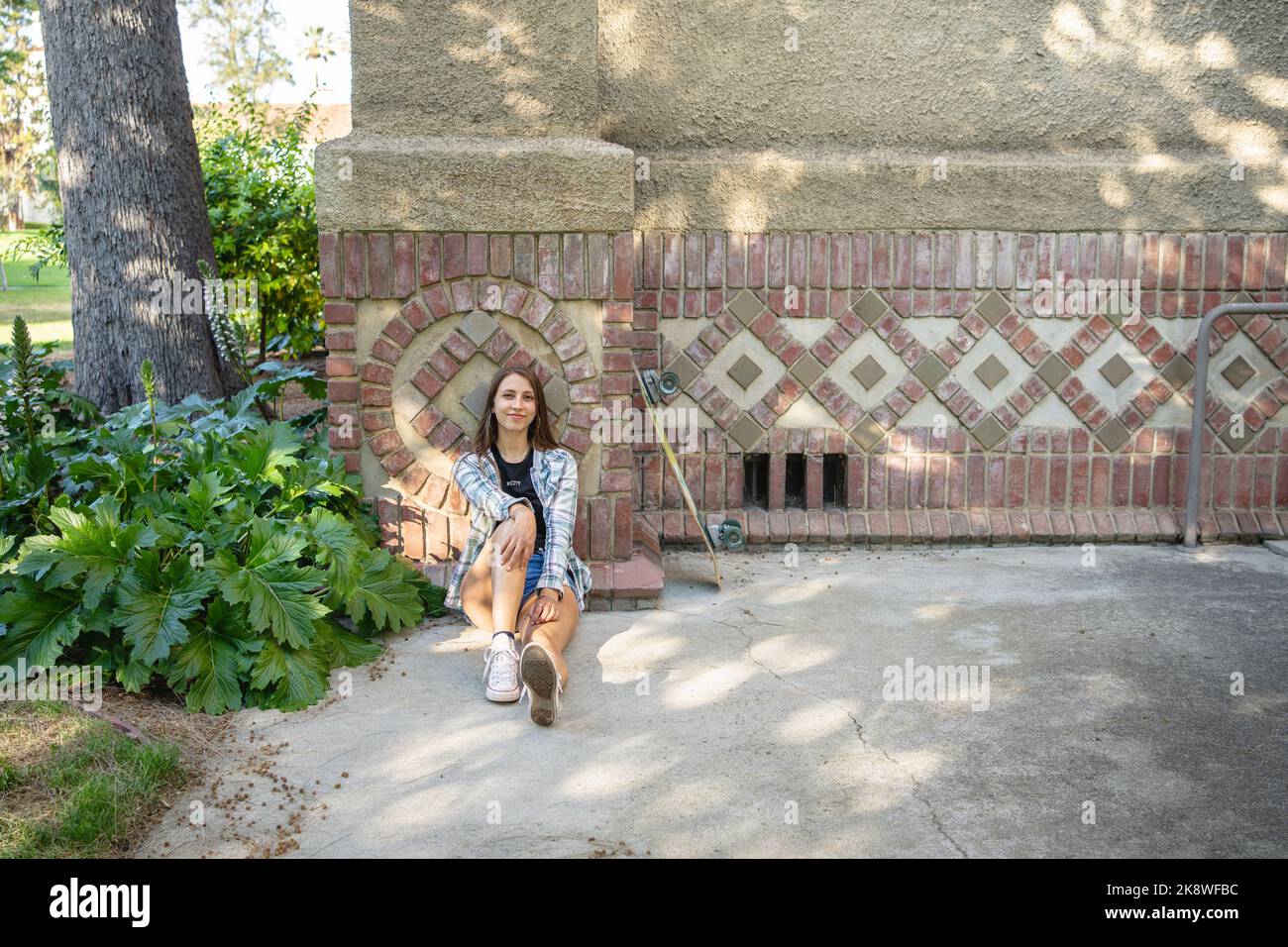Skateboarder Girl Sitting Outside a Building at SJSU Stock Photo - Alamy