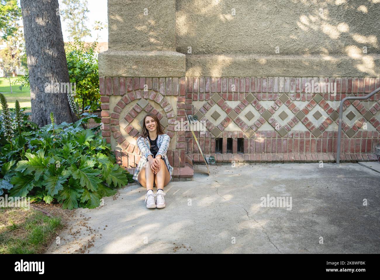 Skateboarder Girl Sitting Outside a Building at SJSU Stock Photo - Alamy