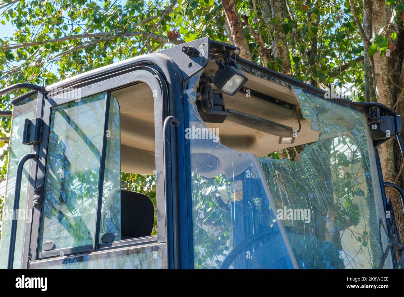 Broken windshield on the cab of an excavator vehicle that was parked on ...