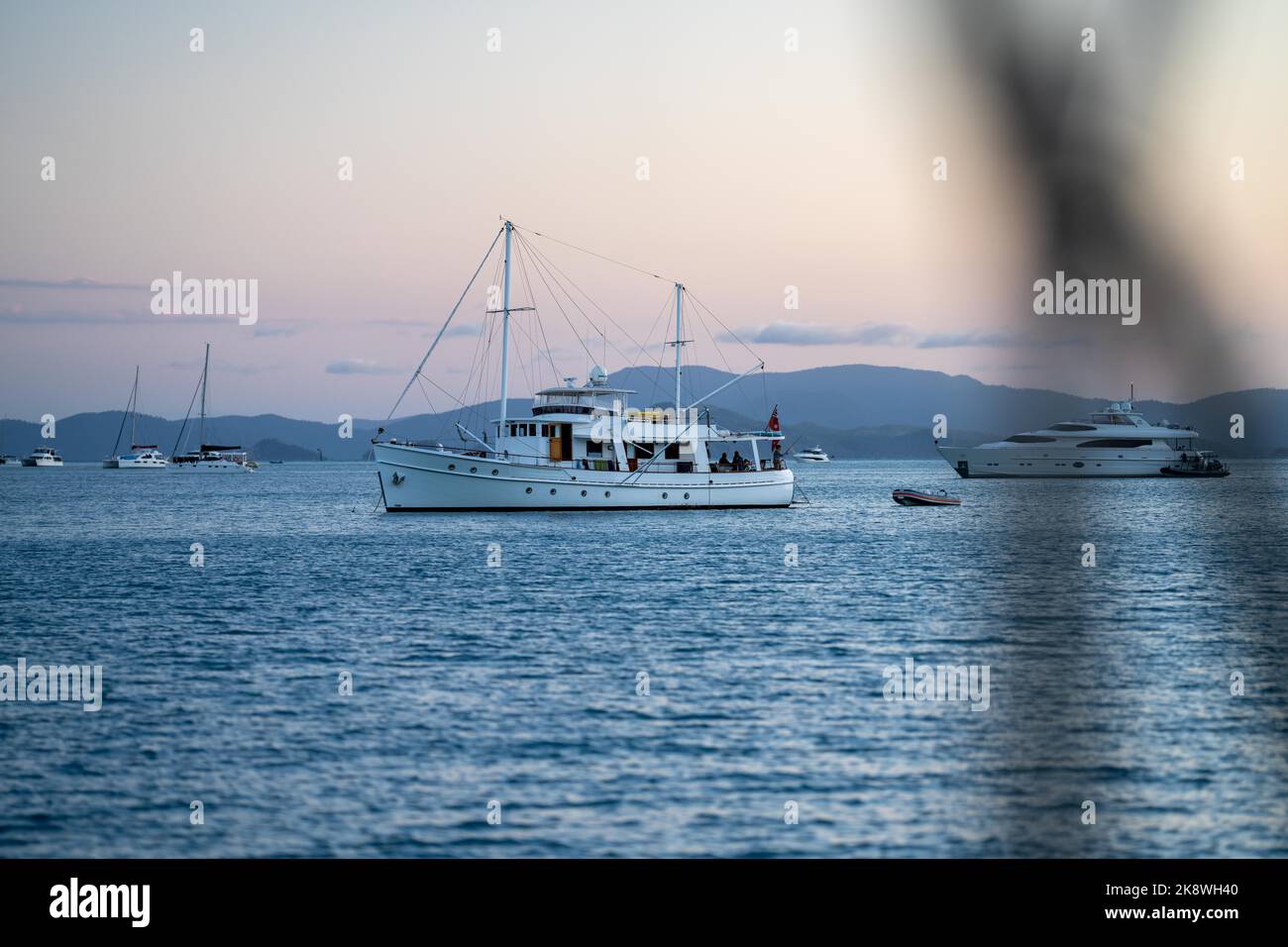 Tropical island in the Great Barrier Reef. coral reef, with yachts ...