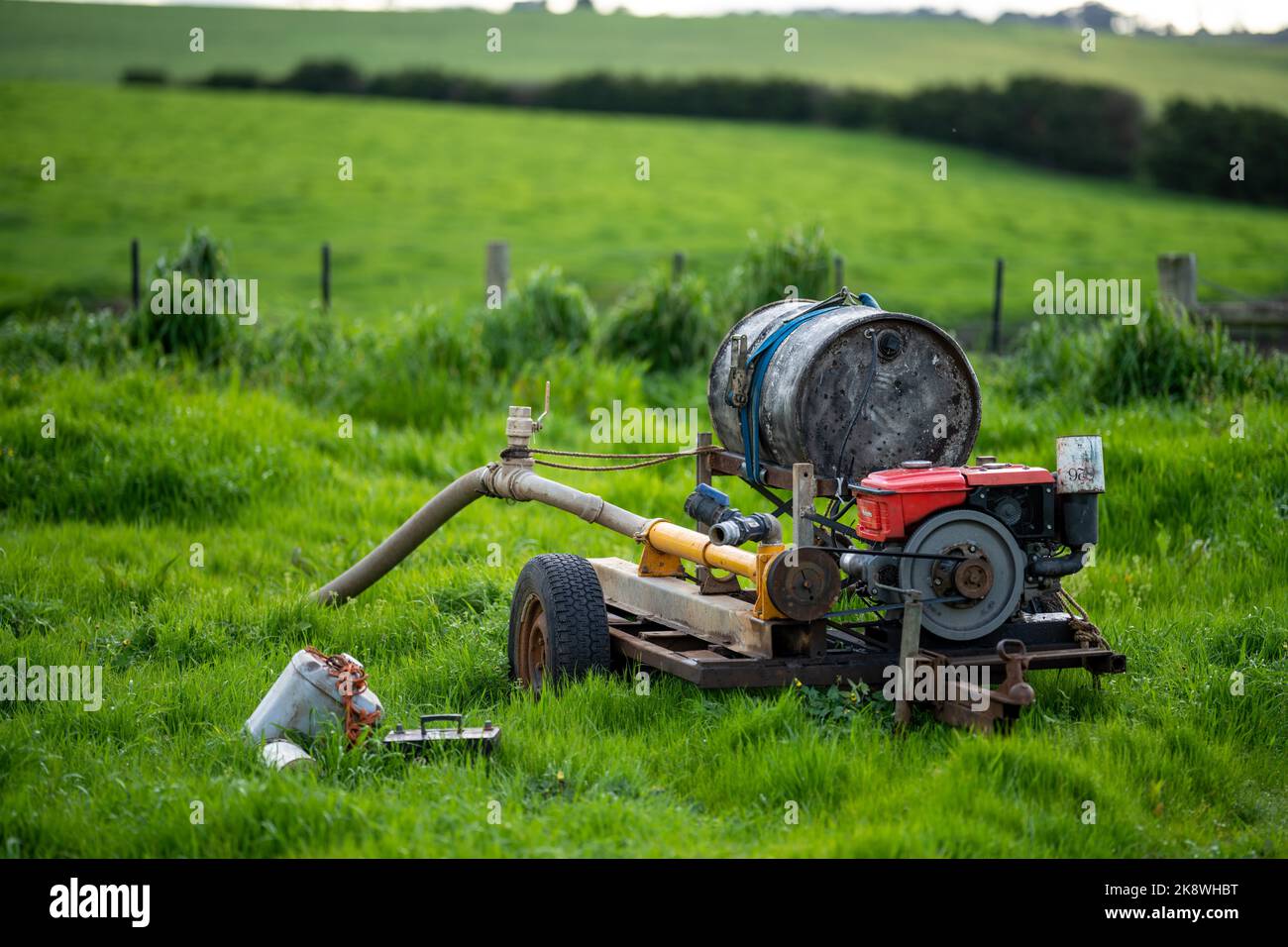 water pump, pumping water on a farm in summer. irrigation on a ranch in ...