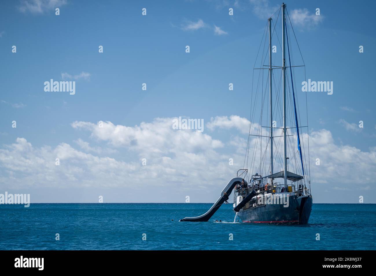 Tropical island in the Great Barrier Reef. coral reef, with yachts ...
