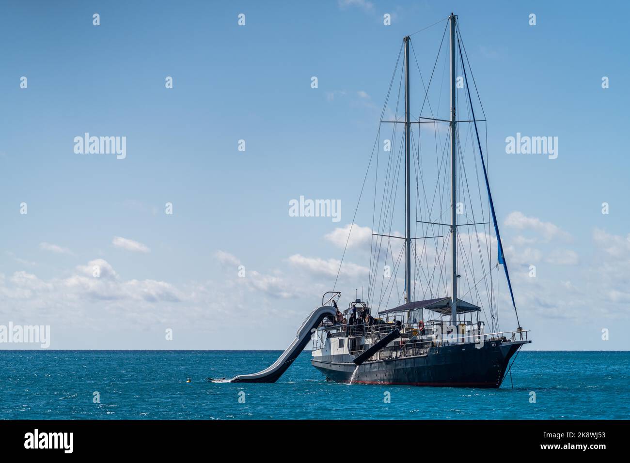 Tropical island in the Great Barrier Reef. coral reef, with yachts ...