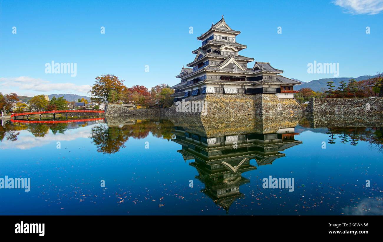 Matsumoto Castle with its reflection captured in an early Fall/Autumn ...