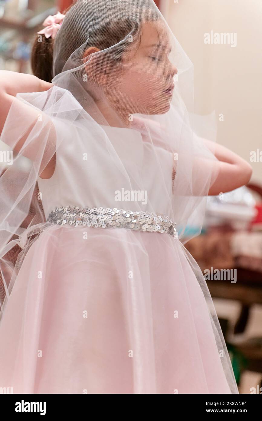 beautiful girl playing with her formal dress while trying it on Stock ...