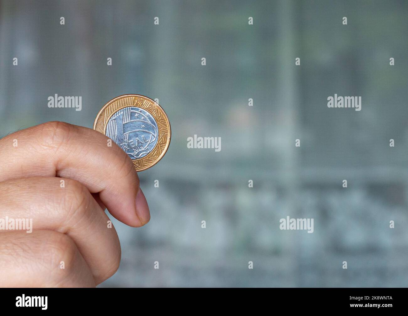 One real coin in the palm of a person's hand. Hand holding a 1 dollar ...