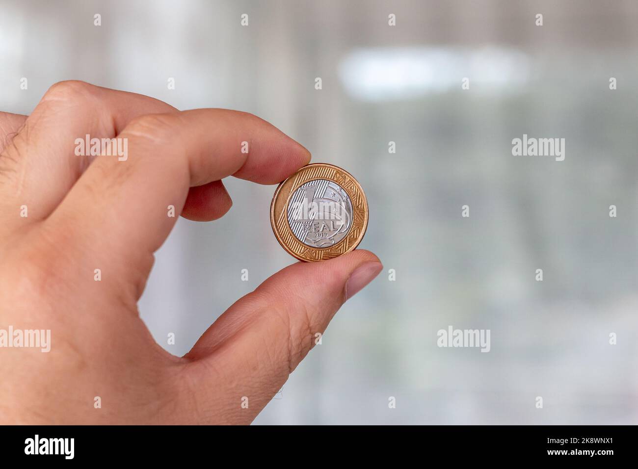 One real coin in the palm of a person's hand. Hand holding a 1 dollar ...