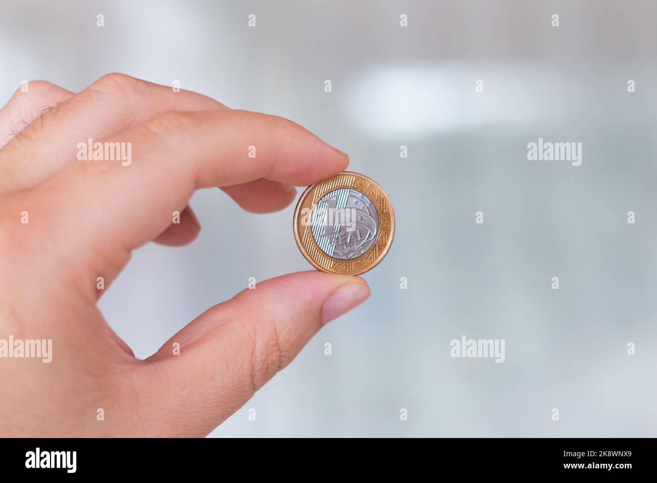 One real coin in the palm of a person's hand. Hand holding a 1 dollar ...