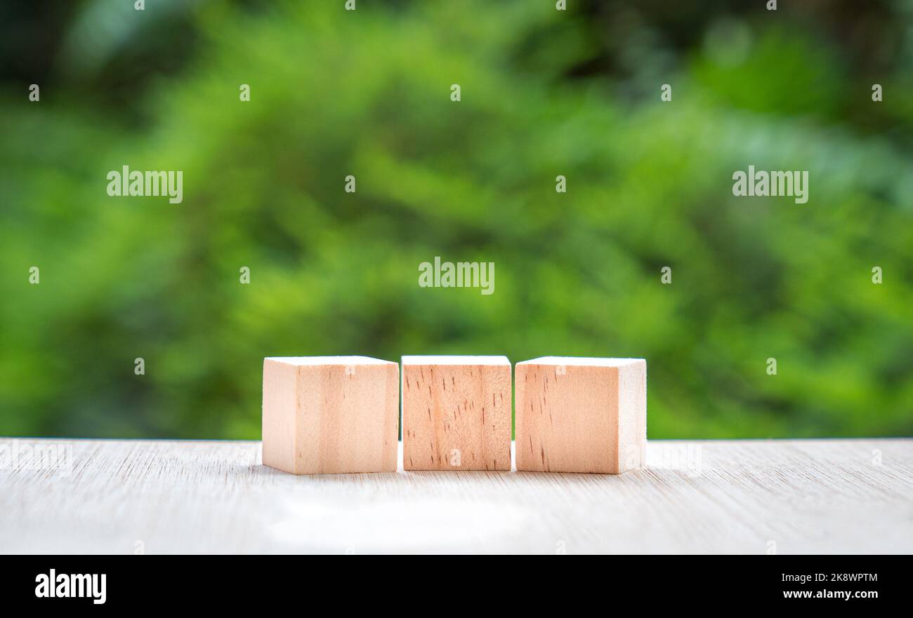 Three blank wood block cubes with green nature background. Mockup or ...