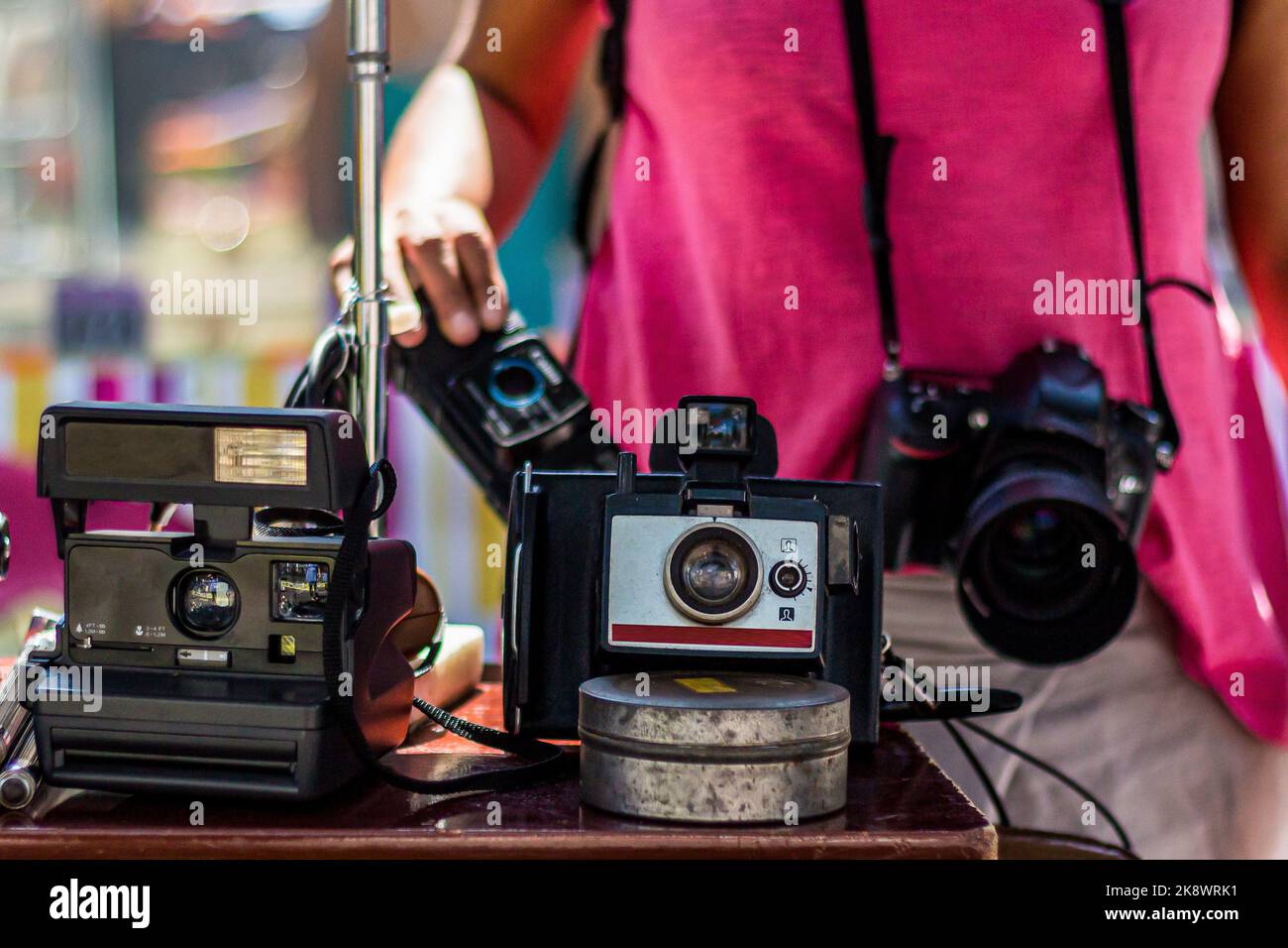 Photographer looking at old cameras Stock Photo - Alamy