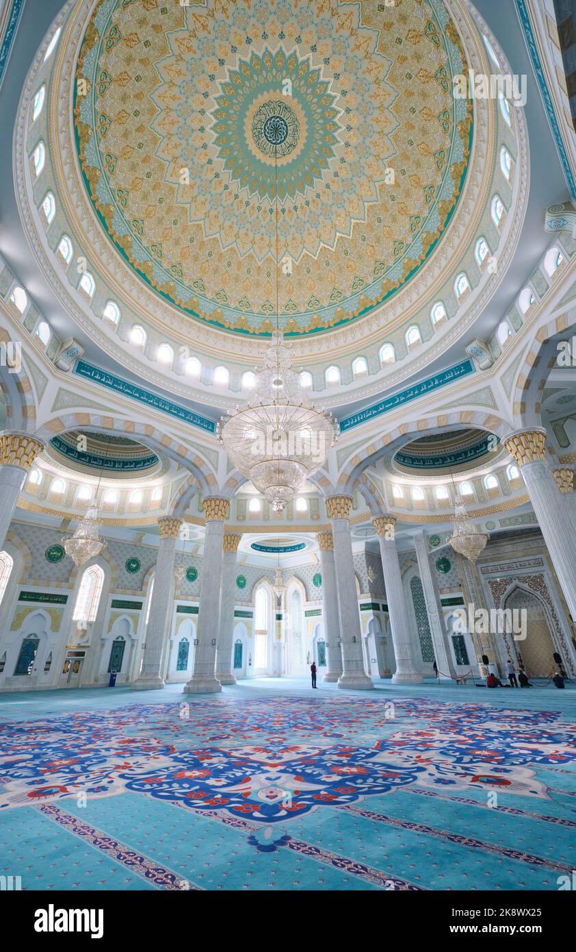 Interior of the richly appointed mosque, with blue-green carpet ...