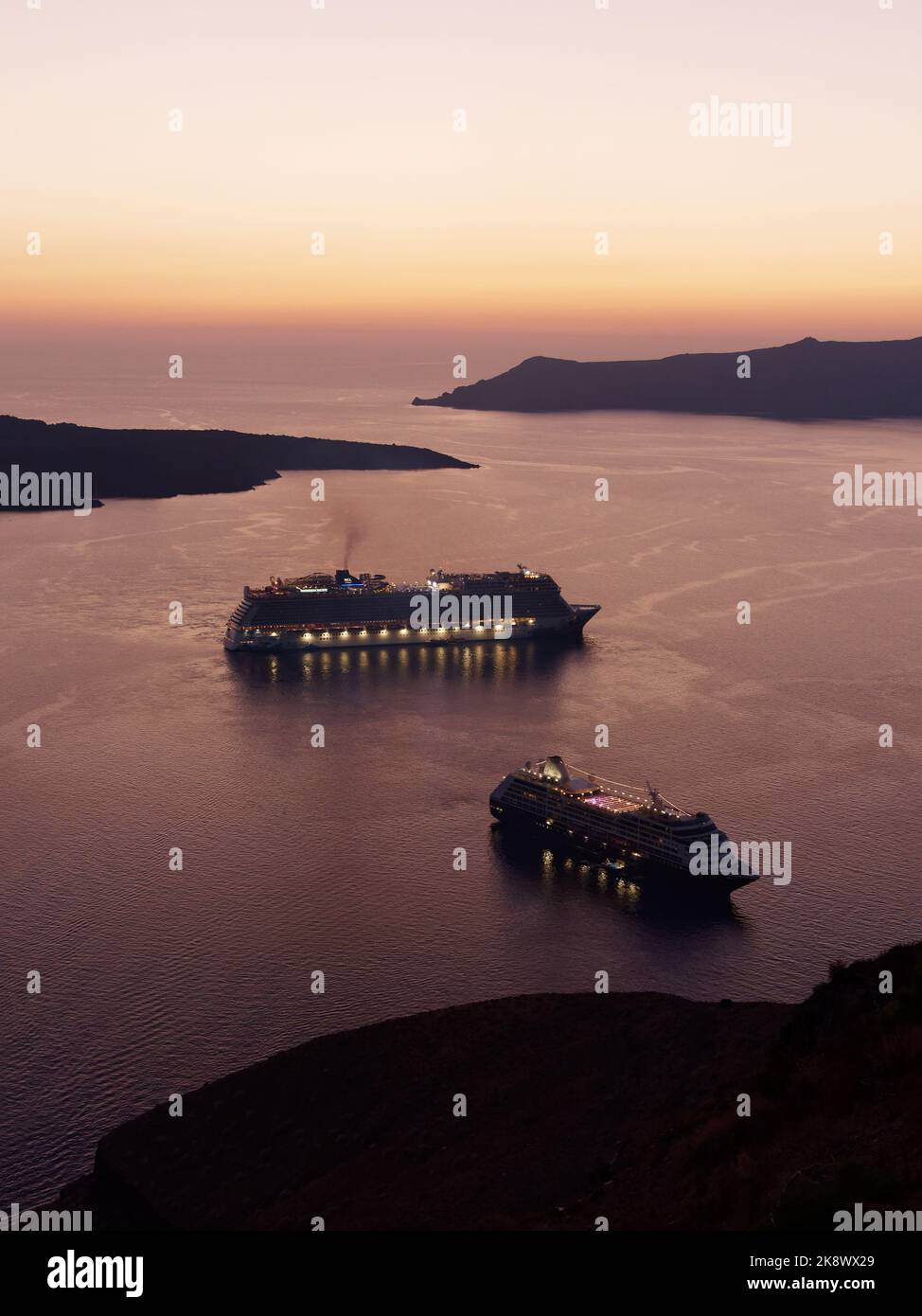 Firostefani view over the Caldera at sunset.with cruise ships. Greek ...