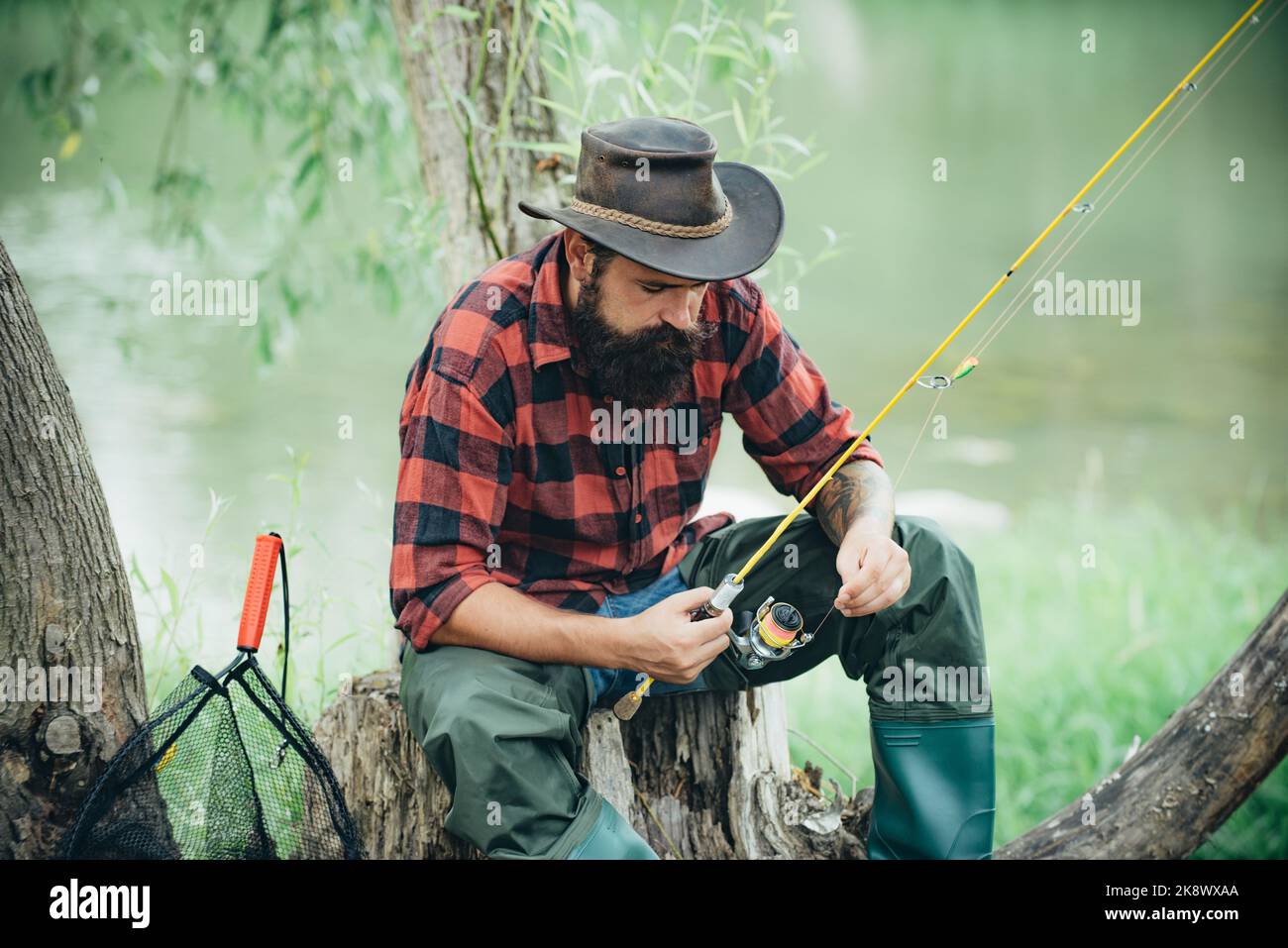 Fisherman caught a fish. Man fishing on river Stock Photo - Alamy