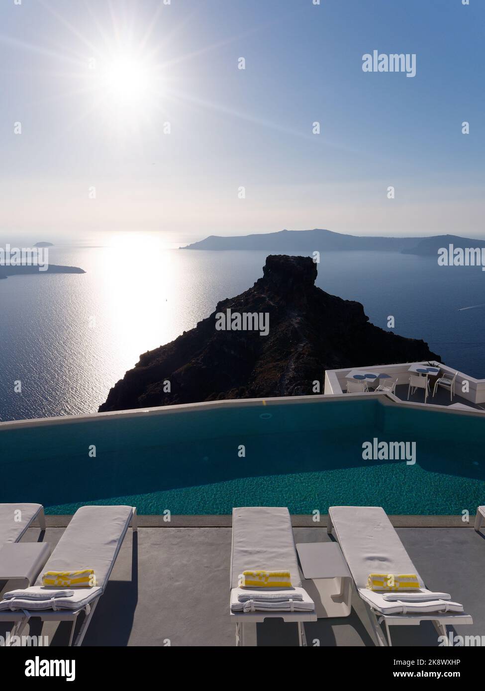 Sun starts to set over Thirasia with Skaros Rock foreground. Aegean ...